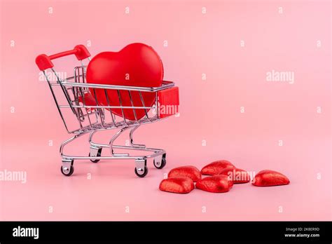 Red Heart In Shopping Trolley And Candies In A Red Wrapper Isolated On