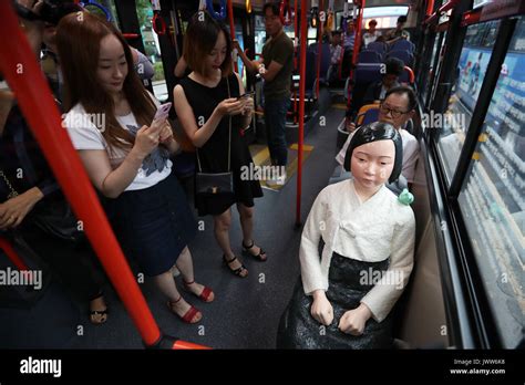 Comfort Woman Statue On Bus Passengers Take Photos Of A Comfort