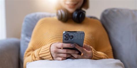 Attractive Asian Woman Resting Comfortable Living Room And Using Mobile