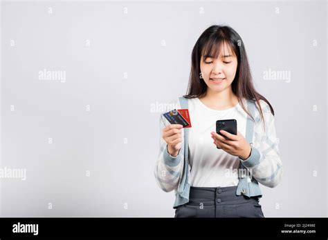 Woman Excited Smiling Hold Mobile Phone And Plastic Debit Credit Bank