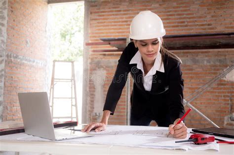 Young Caucasian Architect Woman Looking Laptop And Working Drawing Blueprint For Planning