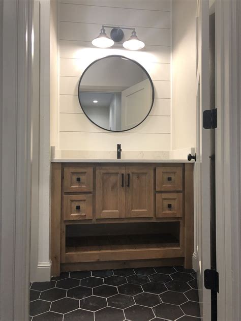 Knotty Alder Stained Cabinet Bathroom With Black Hexagon Flooring