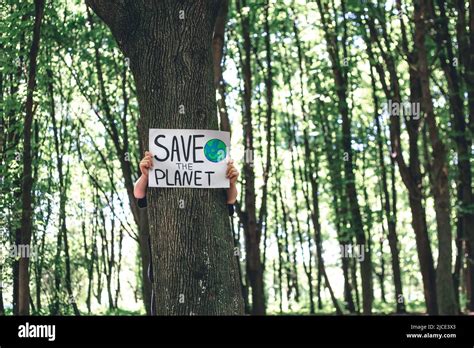 Poster In The Call To Save The Planet In Female Hands In The Forest