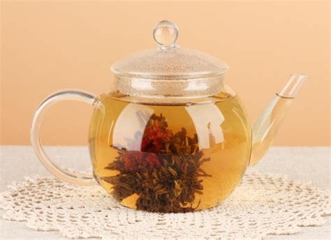 Premium Photo Exotic Green Tea With Flowers In Glass Teapot On Table