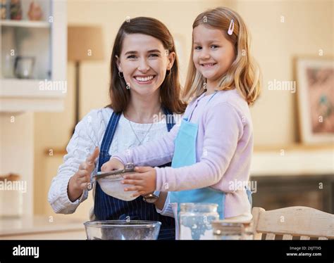 Happy Mother Portrait And Daughter With Baking Sift In Kitchen For