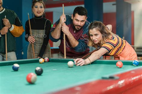 Friends Having Fun Playing Pool In Arcade Fun Times With Friends At