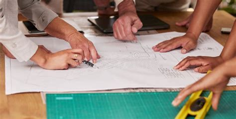Hands Collaboration And Architecture With A Designer Team Planning On A Table Using A Blueprint