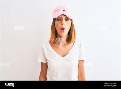 Beautiful Redhead Woman Wearing Sleeping Mask Over Isolated Background