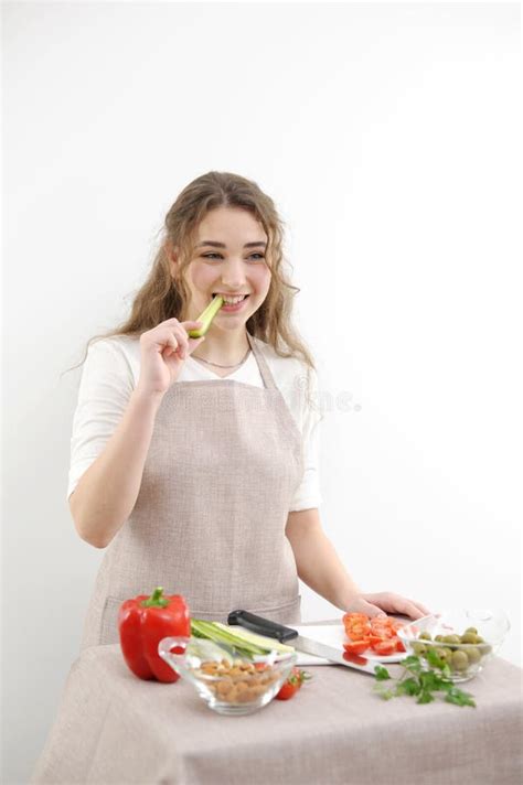 Young Girl Cook Bites Cucumber Prepares Cut Vegetable Or Salad Healthy Food Concept Vegetarian