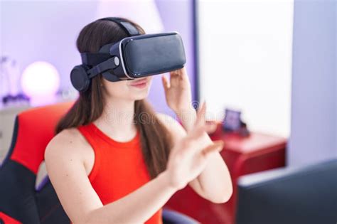 Young Caucasian Woman Streamer Playing Video Game Using Virtual Reality