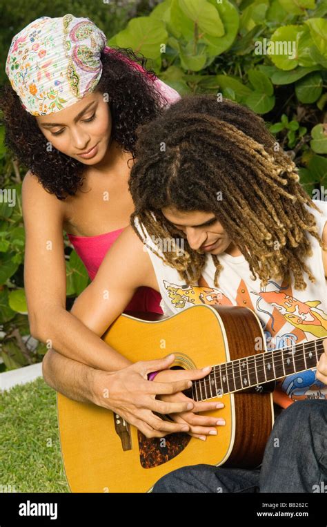 Man Teaching A Woman How To Play A Guitar Stock Photo Alamy