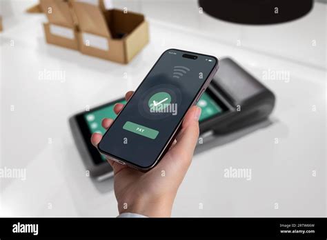 Mobile Phone Completes A Payment On A POS Terminal Showcasing A