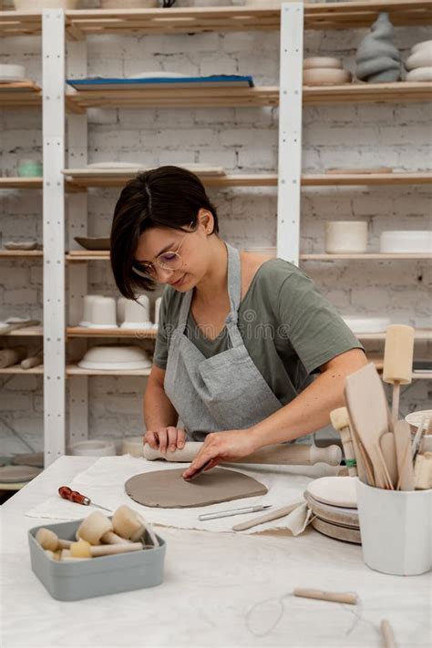 Slab Building Method In Ceramics Crafting Using A Wooden Stick To Roll