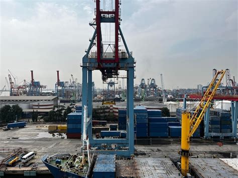 Premium Photo Container Ship Docked In The Port For Loading And