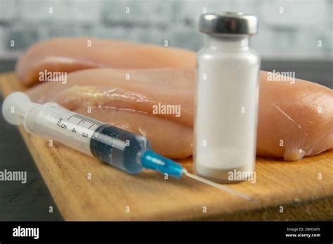Injection Syringe In Raw Chicken Pieces Concept Of Injection Of Gmos