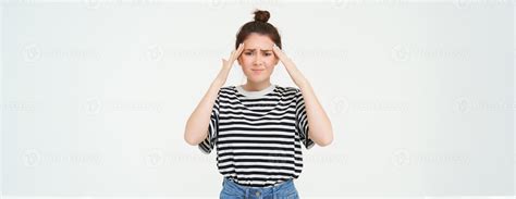 Portrait Of Woman With Headache Touches Her Forehead And Frowns From