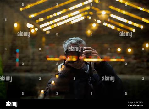 Woman Taking A Photo With A Mirror In The Night With Yellow Light
