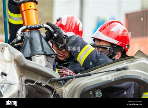 Firefighters Using Hydraulic Tools During A Rescue Operation Training