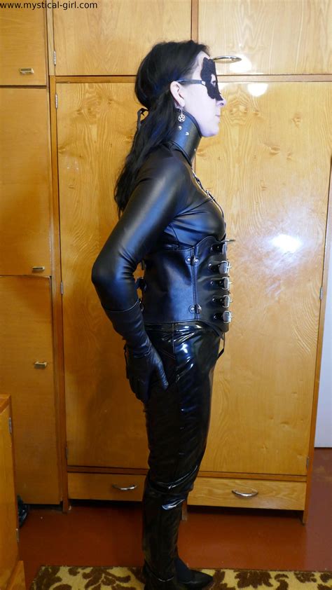 Mystic Mistress Wearing A Black Leather Costume And Pink Leather Mask Photos