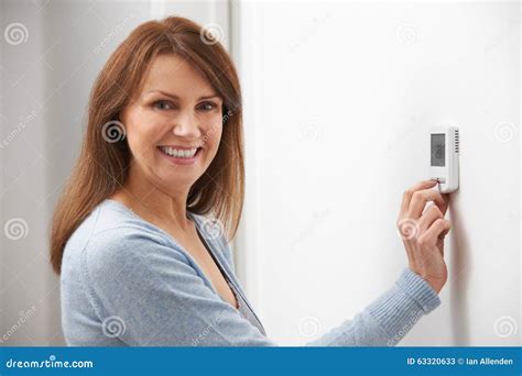 Smiling Woman Adjusting Thermostat On Home Heating System Stock Image Image Of Energy Budget