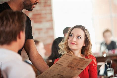 Barbeque Woman Listens To Specials At Restaurant By Stocksy
