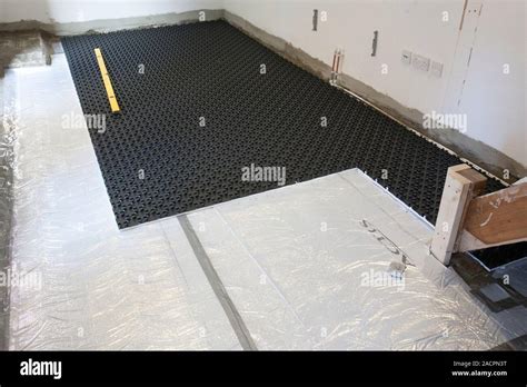 Laying Underfloor Heating Matting Black Being Laid On The Floor Of A