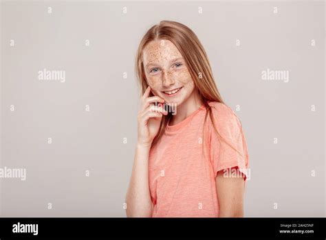 Inclusive Beauty Girl With Freckles Standing Isolated On Grey Touching