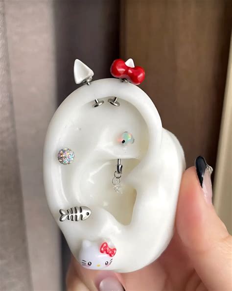Hello Kitty Piercing 🩰🍡 In 2025 Pretty Ear Piercings Cool Piercings Earings Piercings