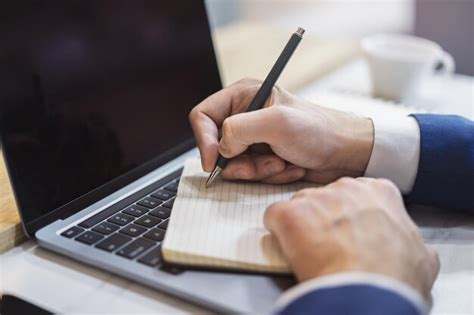 Premium Photo The Image Focuses On A Mans Hand Scribbling In A
