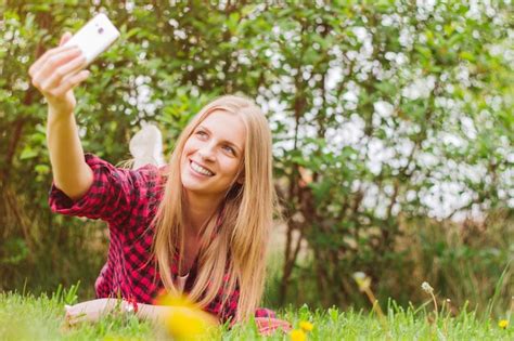Premium Photo Smiling Young Woman Taking Selfie From Mobile Phone