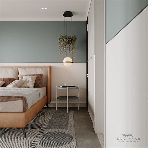 A Bed Sitting In The Middle Of A Bedroom Next To A Table With A Lamp On It