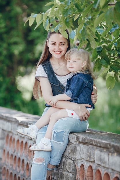 Free Photo Mother Holding Her Daughter In Her Arms