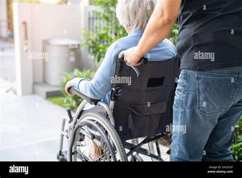 Caregiver Help And Care Asian Senior Or Elderly Old Lady Woman Patient