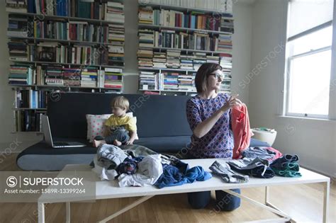 Mother And Son Folding Laundry Superstock