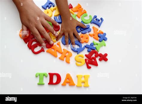 Hands Of Mom And Daughter Playing With Colored Letters That Form Adhd