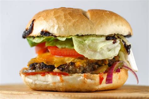 Tasty Cheese Beef Burger With Lettuce Cheddar And Tzatziki Stock Photo