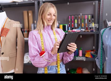 Young Blonde Woman Tailor Smiling Confident Using Touchpad At Tailor