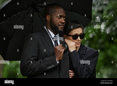 Medium Shot Of Senior Woman Holding Supportive Husband By Arm Grieving