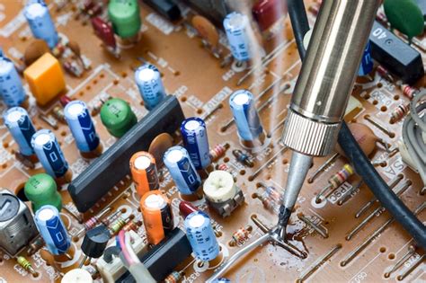 Premium Photo Soldering Iron And Verification Testing Of Electronic Boards