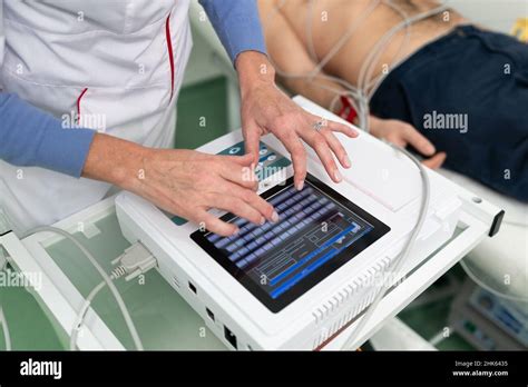 ECG Concept Woman Doctor Cardiologist Doing Electrocardiogram Test To Man Patient In Cardiology