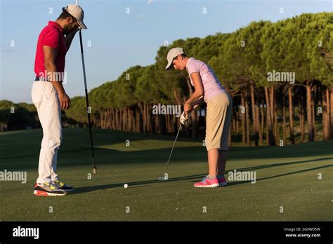 Male Golf Instructor Teaching Female Golf Player Personal Trainer