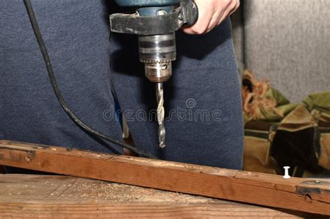Wood Worker Man Using Drill Press Machine For Make A Hole On Wood Parts
