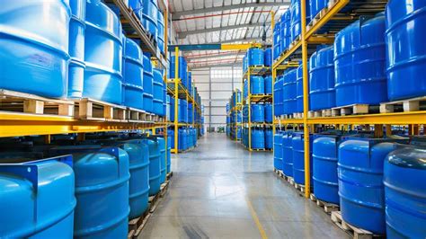 Rows Of Blue Containers Are Neatly Organized In Chemical Storage Warehouse For Easy Access Stock