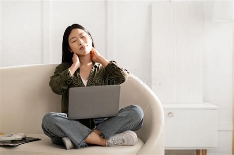 Tired Young Asian Woman Independent Contractor Massaging Her Neck Stock