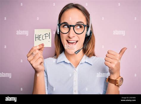 Beautiful Call Center Agent Woman Working Using Headset Holding Help