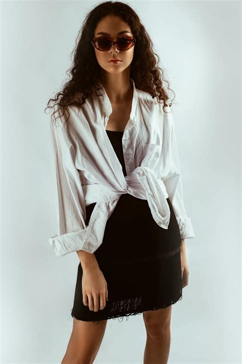 Photo Of Woman In White Shirt Black Dress And Sunglasses Posing In