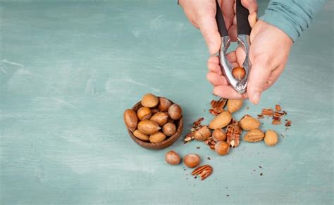 Premium Photo Crack Nuts With A Nutcracker Mix Variety Of Almonds