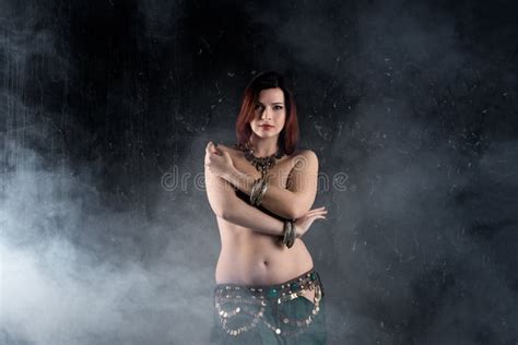 Women Performs Belly Dance In Ethnic Dress On Dark Smoky Background