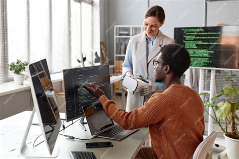 Premium Photo Software Developers Discussing Programming Code When
