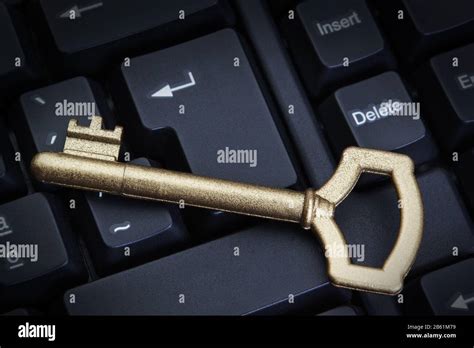 Golden Key On The Keyboard Symbol Of Safety And Protection Stock Photo Alamy